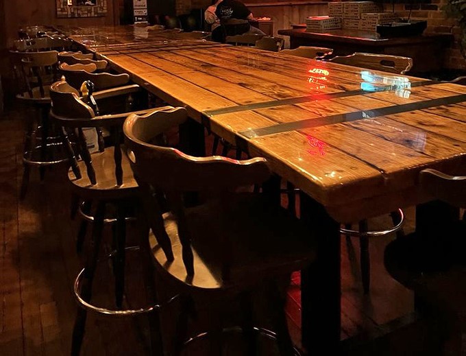 Rustic wooden tables that could tell a thousand stories of first dates, study sessions, and the "I can't believe we ordered this much" moments.