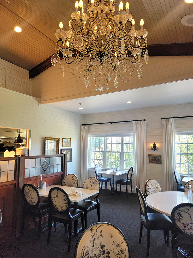 Crystal chandeliers hanging above floral-backed chairs—like your sophisticated aunt married your country uncle and decorated their dream home.