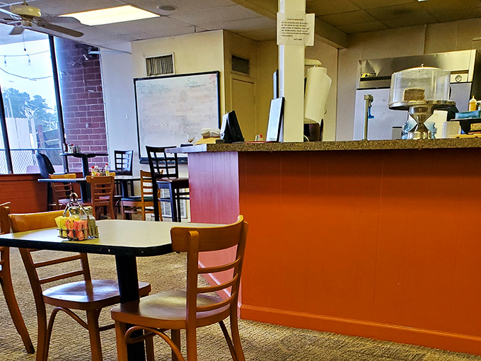 Simple tables, straightforward chairs, and that signature orange counter&mdash;where conversations flow as freely as the coffee.