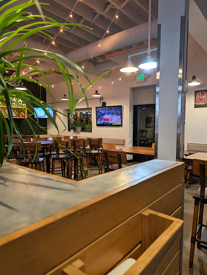 String lights and greenery add just enough warmth to the industrial-chic space, proving they put their energy into the food, not fancy decor.