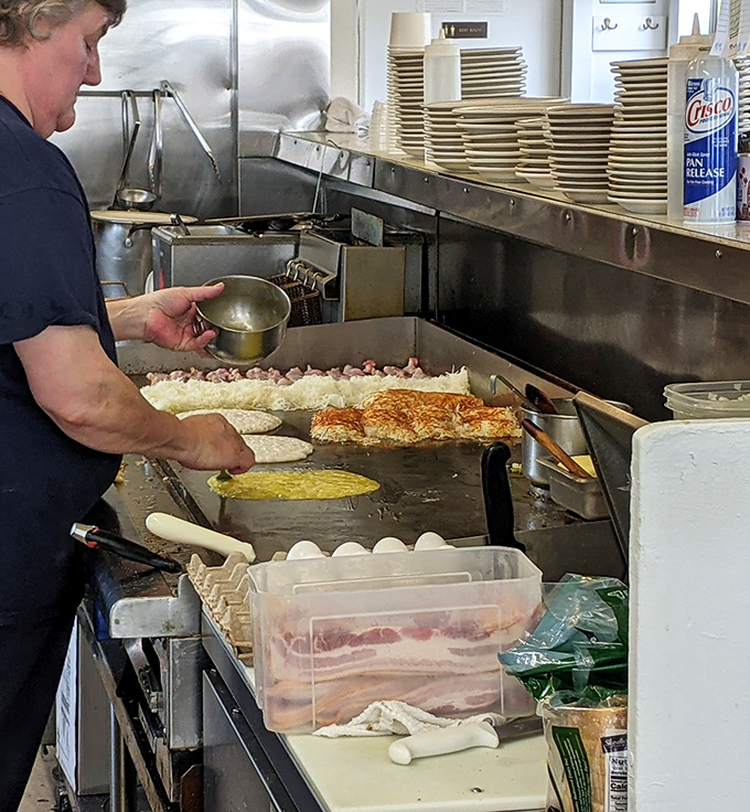 The kitchen ballet&mdash;where breakfast magic happens on a well-seasoned grill that's seen more action than an Oregon logging camp.