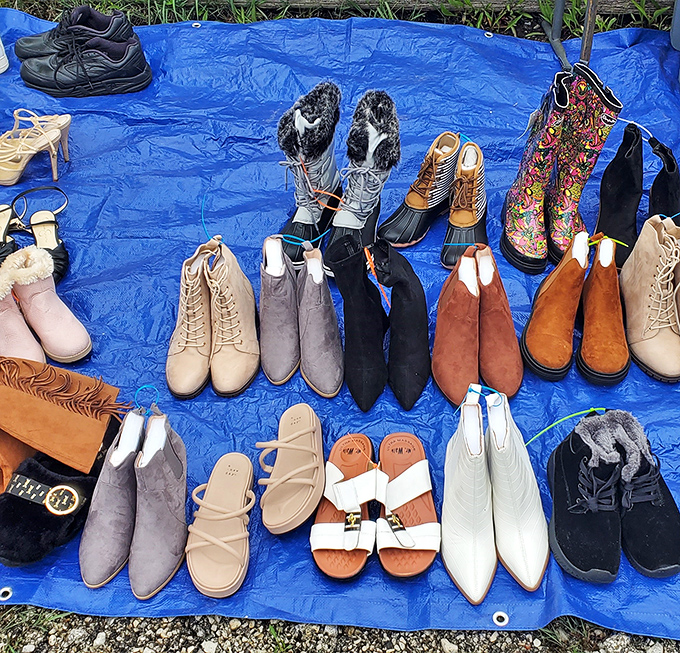 A rainbow of footwear possibilities spread across blue tarp &ndash; from practical boots to stylish ankle booties, all waiting for their Cinderella moment.