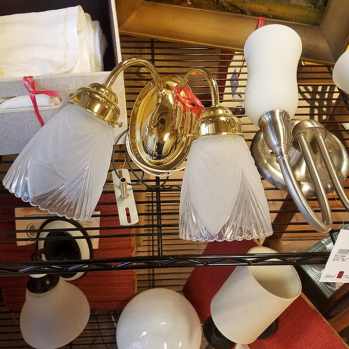 Lighting fixtures that could make even the DMV feel fancy. Those frosted glass shades are like little wedding dresses for your electricity.