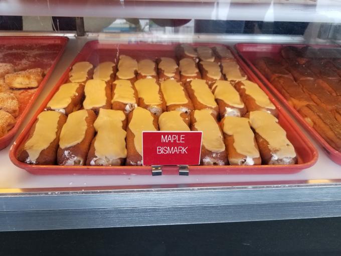 Rows of fresh Maple Bismark donuts waiting to be enjoyed at Crispie Creme, Chillicothe—sweet, creamy, and perfectly irresistible.