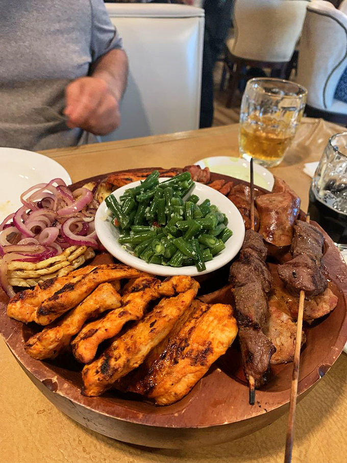 A meat lover's dream platter that would make Ron Swanson proud—grilled perfection surrounded by colorful sides that aren't just playing supporting roles.