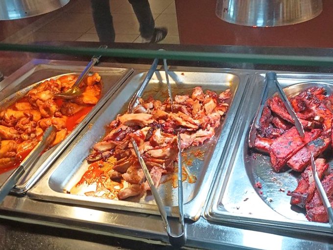 The meat station—where barbecue dreams come true in technicolor. That vibrant red char isn't just color—it's the flavor billboard advertising what's to come.