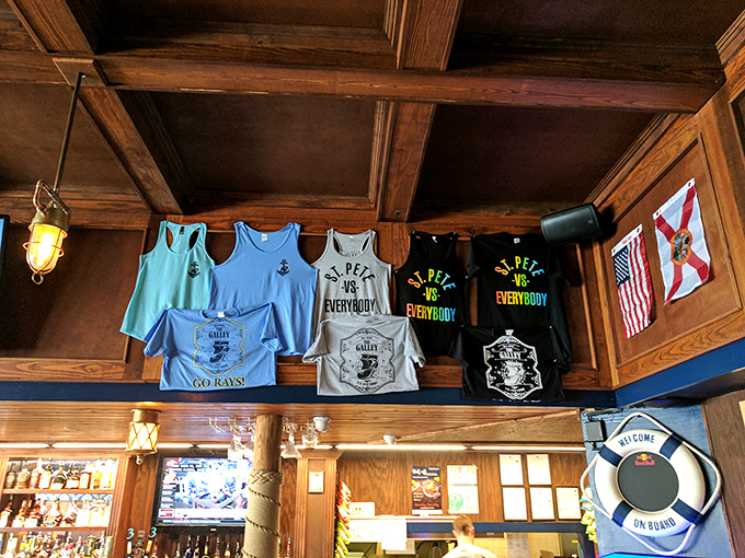 The merch wall proudly displays the "St. Pete vs. Everybody" motto&mdash;wear your allegiance to this culinary gem with pride.