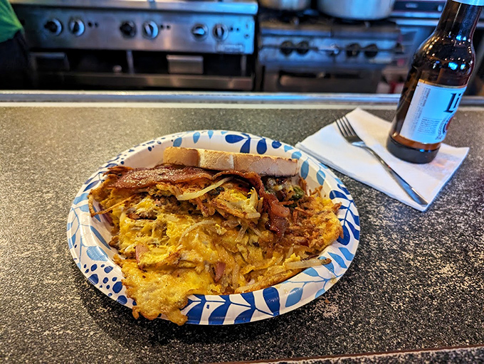 A breakfast scramble that doesn't know the meaning of restraint &ndash; eggs, cheese, and meat in perfect harmony on that distinctive blue-patterned plate.