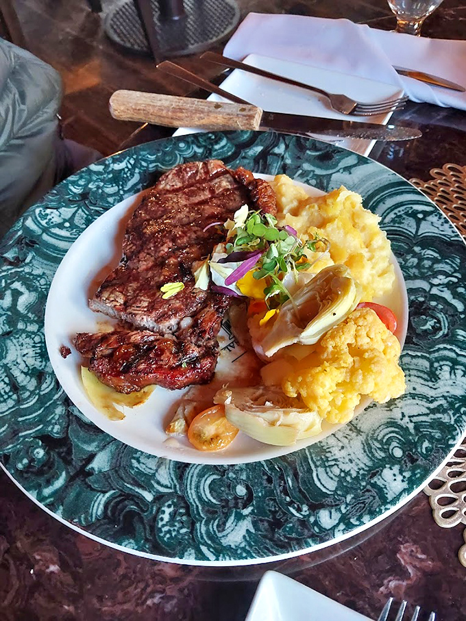 Steak that's been introduced to heat with just the right amount of respect. Those mashed potatoes look cloud-soft enough to nap on.