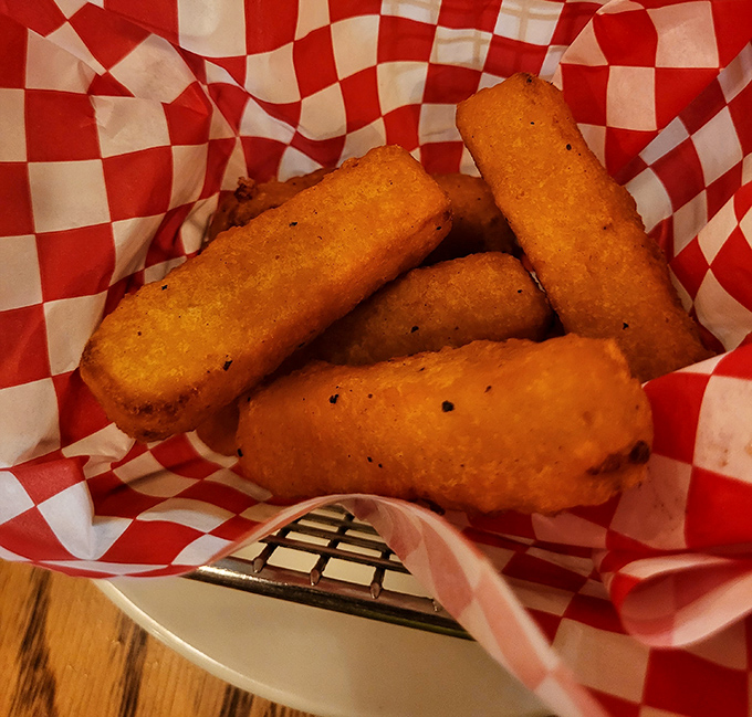 Cheese sticks that stretch for days, nestled in their red-checkered cradle. The kind of appetizer that makes you forget you ordered an actual meal.