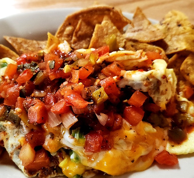 Nachos that understand the importance of proper cheese distribution. Every chip has a fighting chance at greatness here.