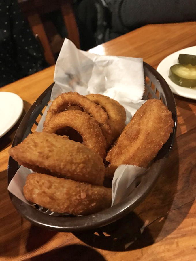 Onion rings arrive like golden halos of crispy perfection, proving that some circles are definitely worth completing.