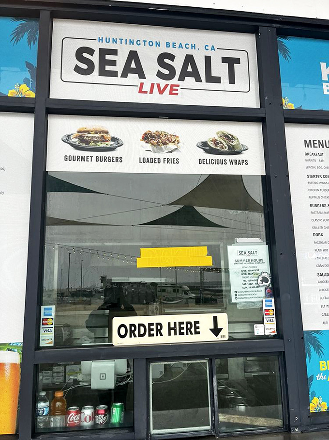 The gateway to gastronomic happiness. Sea Salt's ordering window promises "Gourmet Burgers," "Loaded Fries," and "Delicious Wraps" &ndash; three pillars of beachside contentment.