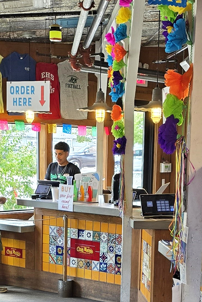 The order counter – where dreams are placed and burger magic begins. Note the colorful tiles that scream "San Antonio!"