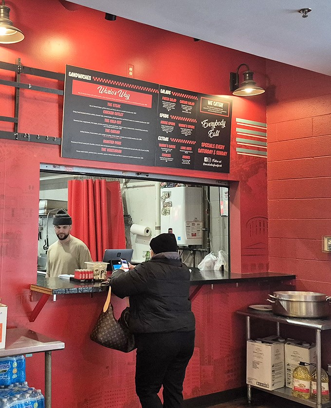 The ordering counter: where dreams are placed and sandwich magic begins. That menu board is basically a roadmap to happiness.