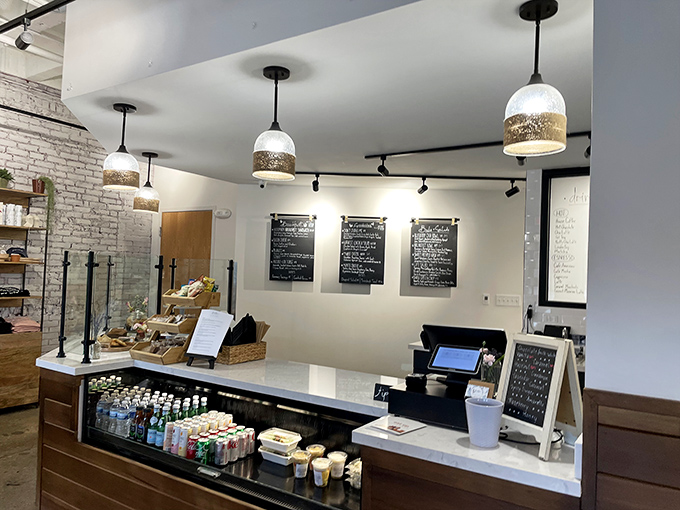 The counter where dreams come true, one pastry and perfectly pulled espresso at a time. Those pendant lights aren't just illuminating space—they're spotlighting culinary magic.