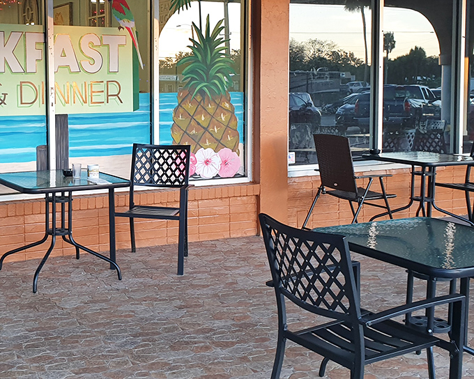 Outdoor seating with tropical flair. That pineapple mural isn't just decoration&mdash;it's a promise of the sweet experience waiting inside.