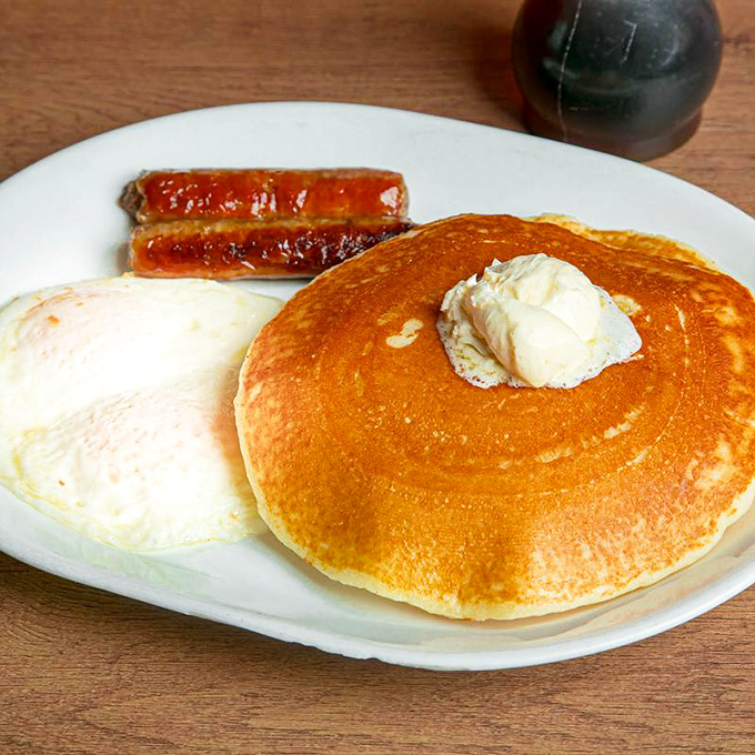 The platonic ideal of a pancake &ndash; golden, fluffy, and supporting a melting pat of butter like it was born for this purpose.