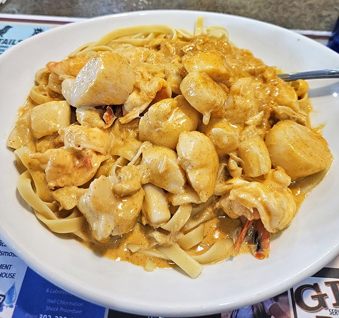 Seafood pasta swimming in golden sauce &ndash; proof that Delaware's proximity to water translates directly to deliciousness on your plate.