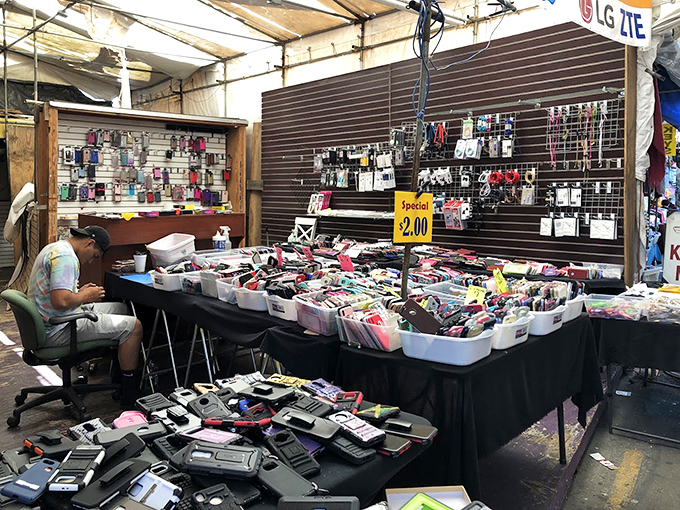 The modern bazaar in action&mdash;where vendors transform simple tables into organized displays of phone cases, creating a tech accessory rainbow. 