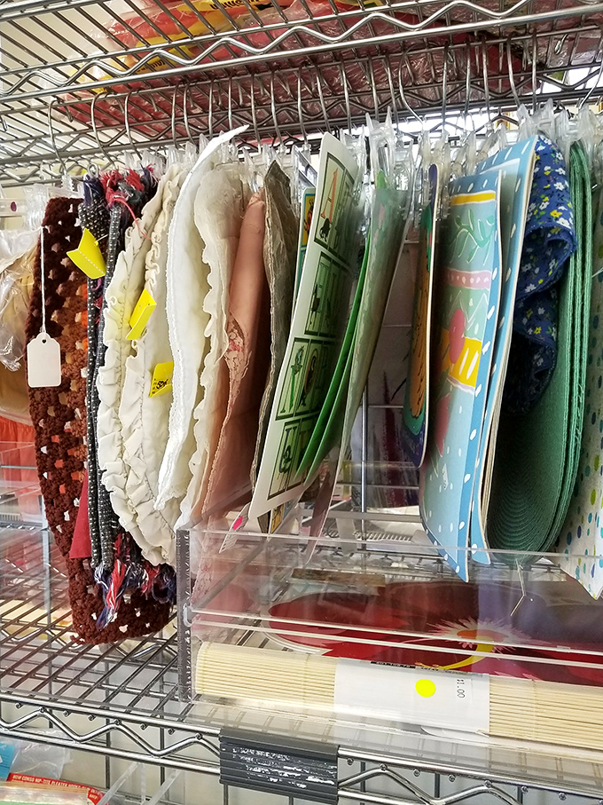 Placemats and table linens neatly arranged like library books. That dinosaur pattern might be exactly what your dining table has been missing all these years.