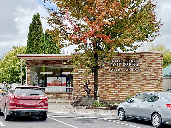 Even the post office gets the mountain view and bronze statue treatment. Mail delivery with a side of majesty.
