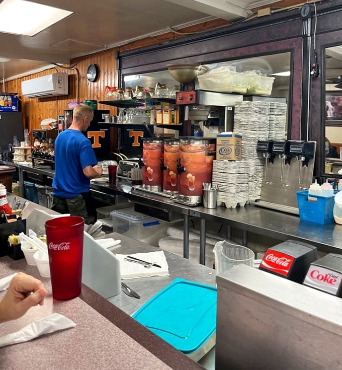 Behind-the-scenes glimpse of where breakfast magic happens, complete with sweet tea dispensers and organized chaos that works.