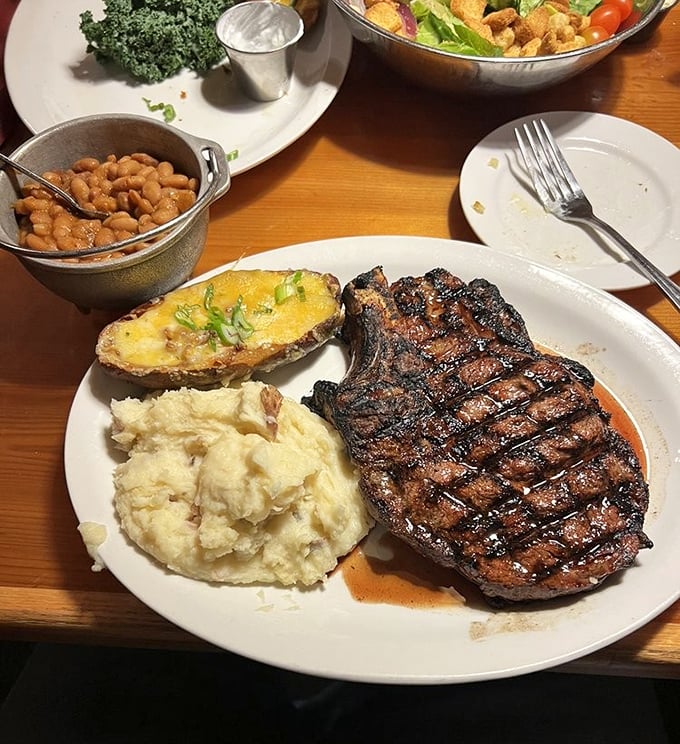 A ribeye with perfect grill marks flanked by sides that know their supporting role&mdash;this plate has better composition than most Hollywood films.