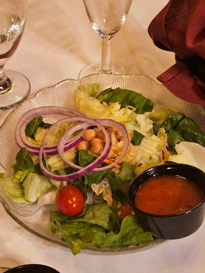 Even the house salad gets the royal treatment &ndash; crisp greens, purple onions, and a dressing that doesn't know it's supposed to be the opening act.