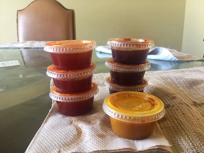 Sauce containers lined up like little soldiers, each ready to enhance your barbecue experience. The different colors hint at flavor journeys waiting to happen.