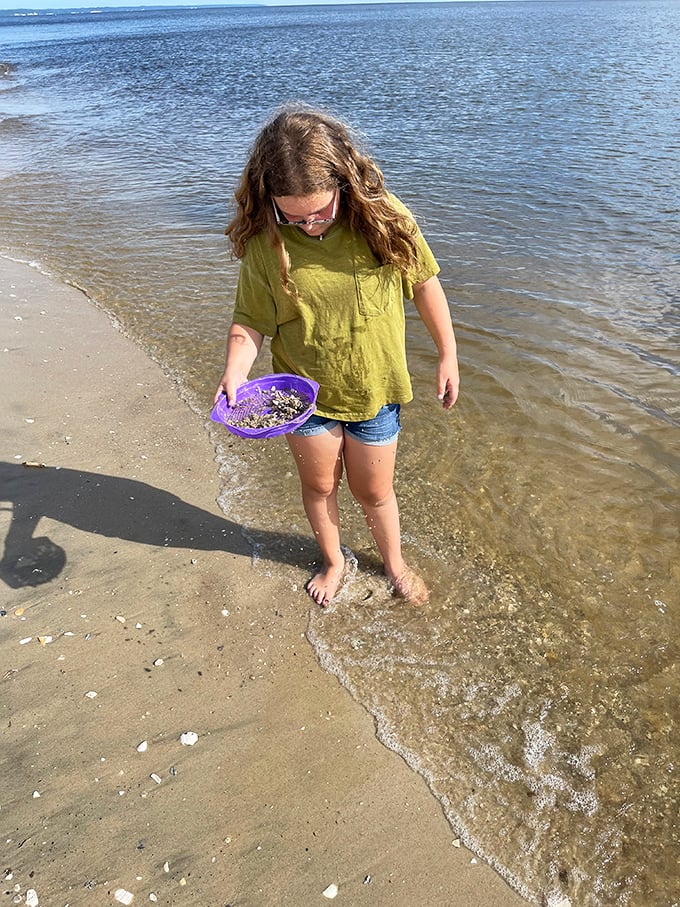 Treasure hunting, childhood edition. This young explorer discovers that the best souvenirs don't come from gift shops but from the shoreline itself.