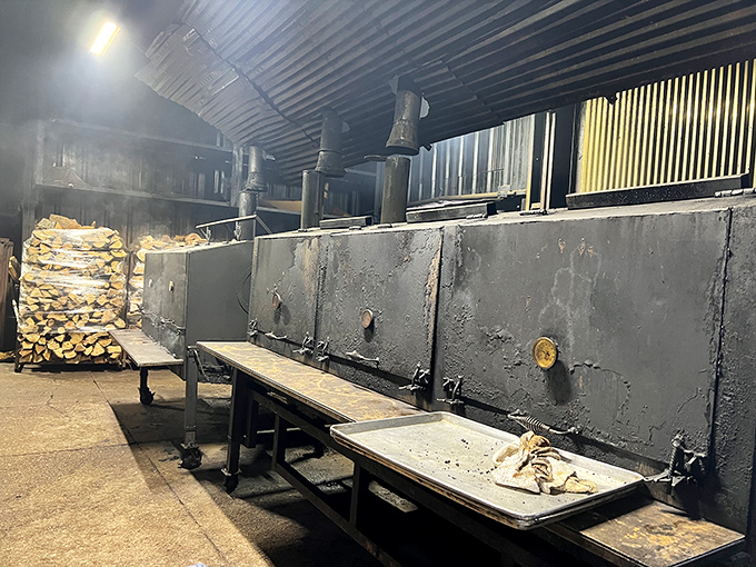 The smoke room: where patience transforms wood and meat into art. Like a cathedral of BBQ, the stacked wood is both fuel and sacrament.