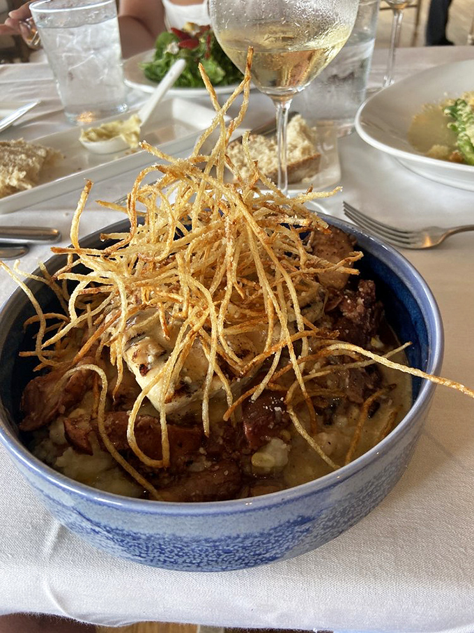 This isn't just dinner&mdash;it's edible architecture where crispy potato straws crown a masterpiece of flavor beneath.