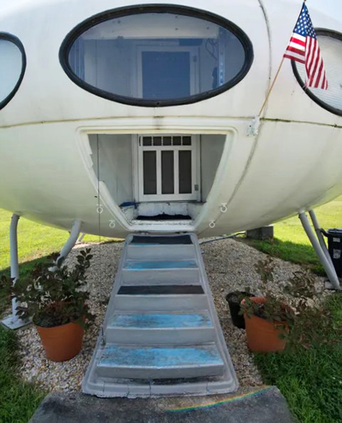 "One small step" up these blue-tinted stairs leads to one giant leap into retro-futuristic living inside this preserved architectural oddity.