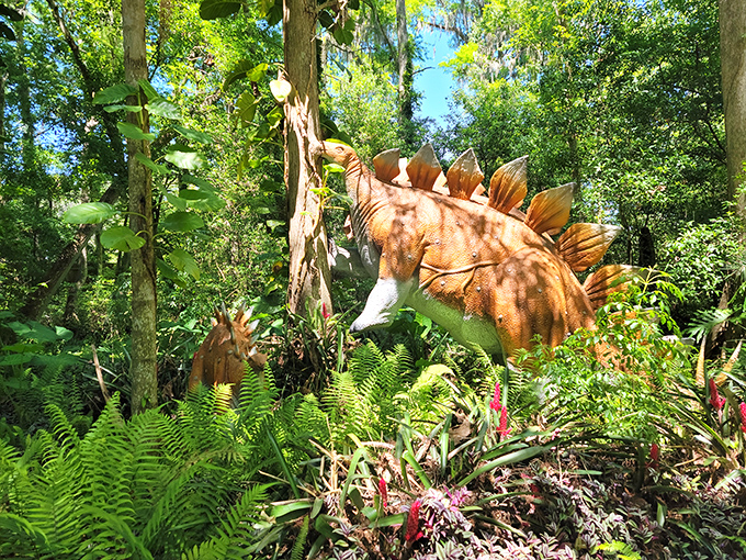The Stegosaurus blends perfectly with Florida's lush landscape, those iconic plates catching dappled sunlight through the canopy of trees.