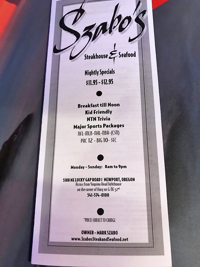 The sign tells you everything you need to know: steaks, seafood, sports, and a location across from a lighthouse. Navigation made delicious.