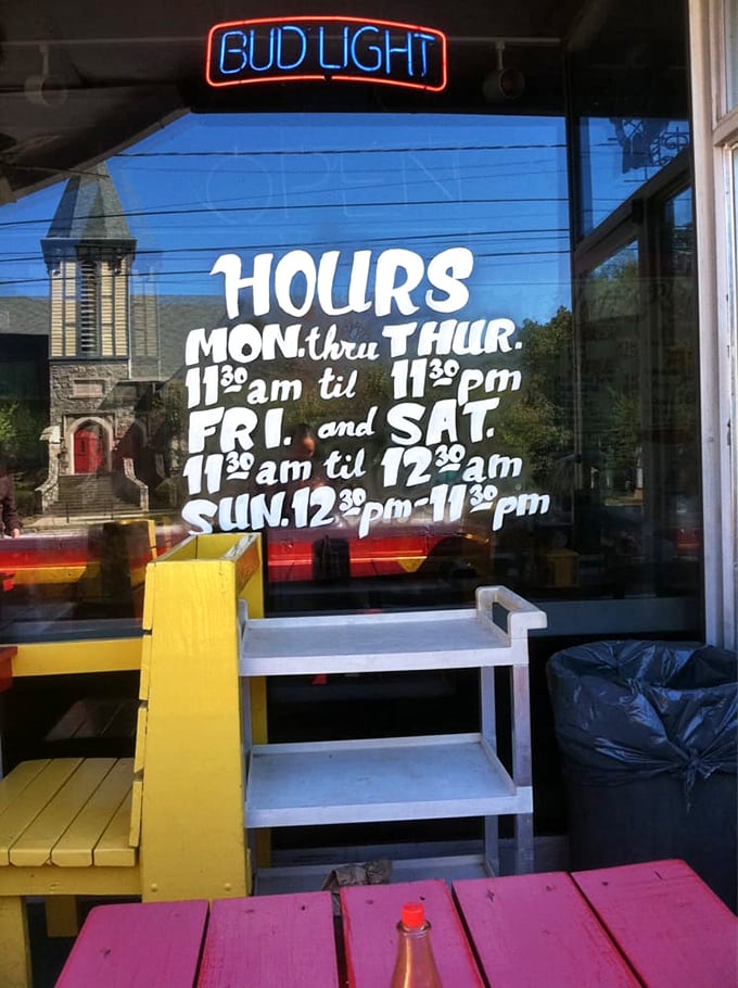 Hours posted like a promise: "Yes, we're here when you need us." The neon beer sign above adds, "And we're ready for you."