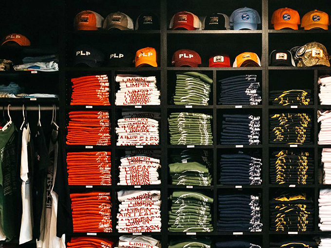 The merchandise wall isn't just selling t-shirts; it's offering you the chance to be a walking billboard for your newfound barbecue religion.