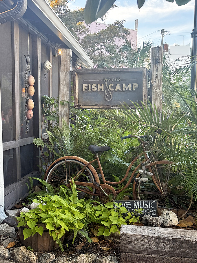 The weathered sign and rusty bicycle announce that you've arrived somewhere authentic, not some corporate seafood theme park.