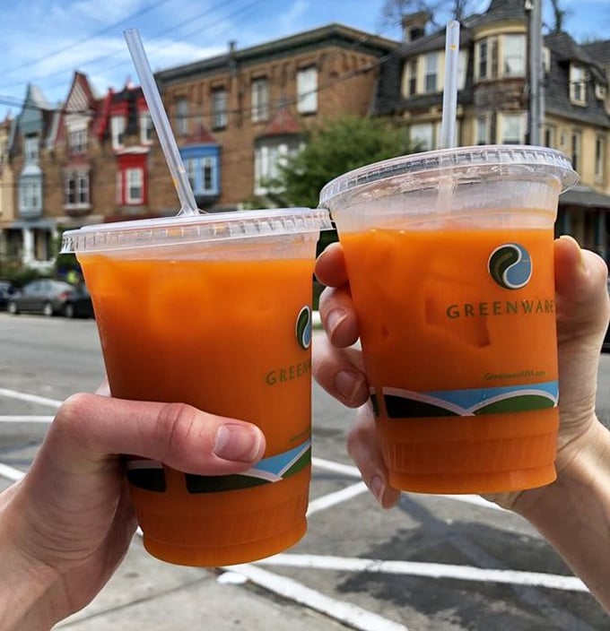 These vibrant Thai iced teas against Philadelphia's classic row houses create the perfect urban refreshment moment worth sharing.