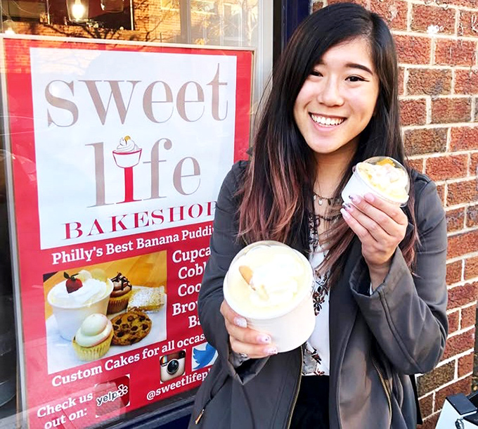 The universal expression of dessert joy&mdash;holding not one but two containers of banana pudding while standing outside the bakery, because waiting until you get home isn't an option.