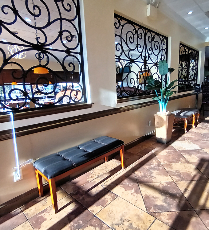 Wrought iron dividers and amber pendant lights create a waiting area that says, "Good things come to those who wait... for pancakes."