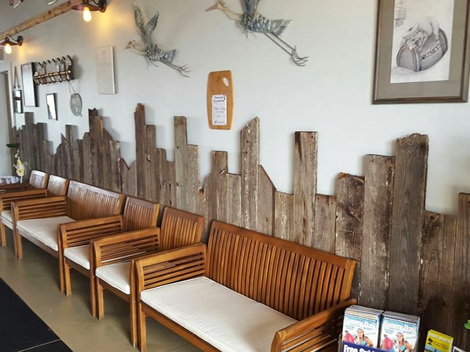 Weathered wood paneling and metal herons on the wall &ndash; Florida dining d&eacute;cor that says "we care more about what's on your plate than what's on our walls."