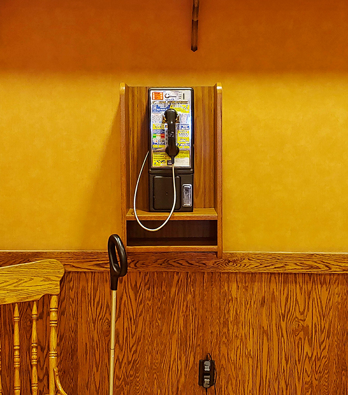 The payphone on a yellow wall&mdash;a charming reminder of the era when "texting during dinner" meant passing notes.