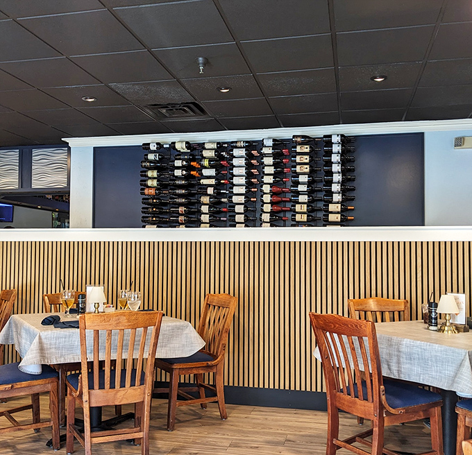 The wine wall stands like a liquid library&mdash;each bottle a story waiting to complement your seafood adventure.