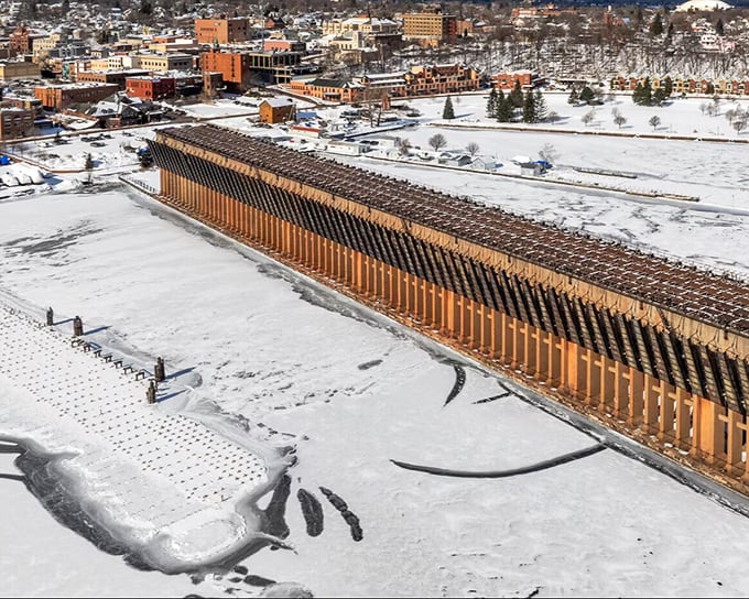 Winter transforms Marquette's ore dock into a snow-dusted industrial cathedral, standing sentinel over the frozen harbor like a scene from a Nordic fairy tale.