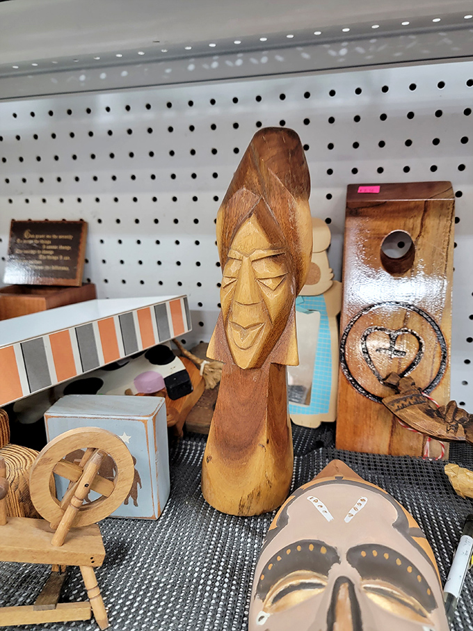 Wooden faces stare back with expressions that say, "Yes, I'm from someone's 1970s vacation, and I'm ready to judge your living room now."