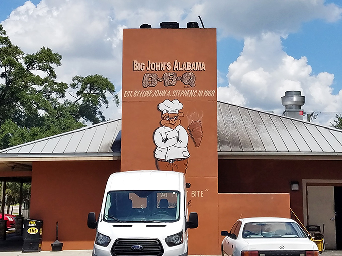Big John's cheerful chef mascot promises Alabama-style hospitality with every perfectly smoked bite you take.