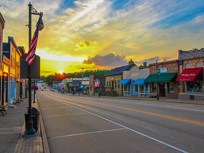 A golden sunset bathes Cambridge's main street in warm light, transforming ordinary storefronts into a scene worthy of a small-town movie set.