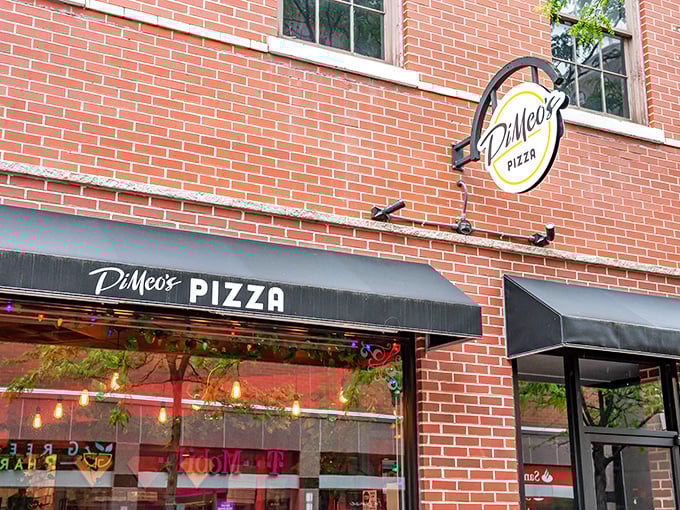 DiMeo's circular sign swings with urban pizza promise. That black awning isn't just stylish&mdash;it's sheltering sidewalk pizza dreams.